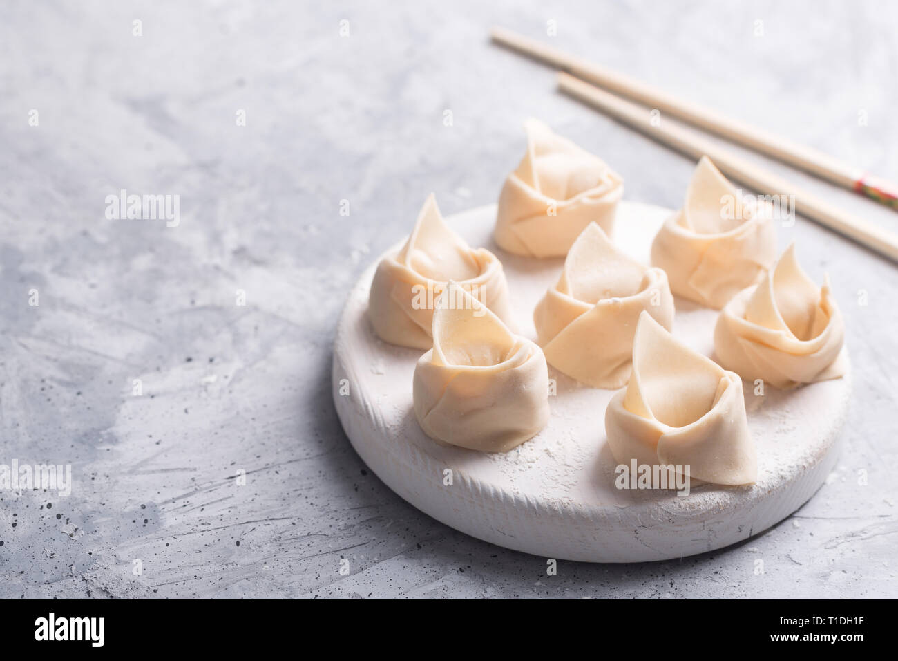 Raw wonton, a Chinese dish made from dough and filling, such as meat or ...