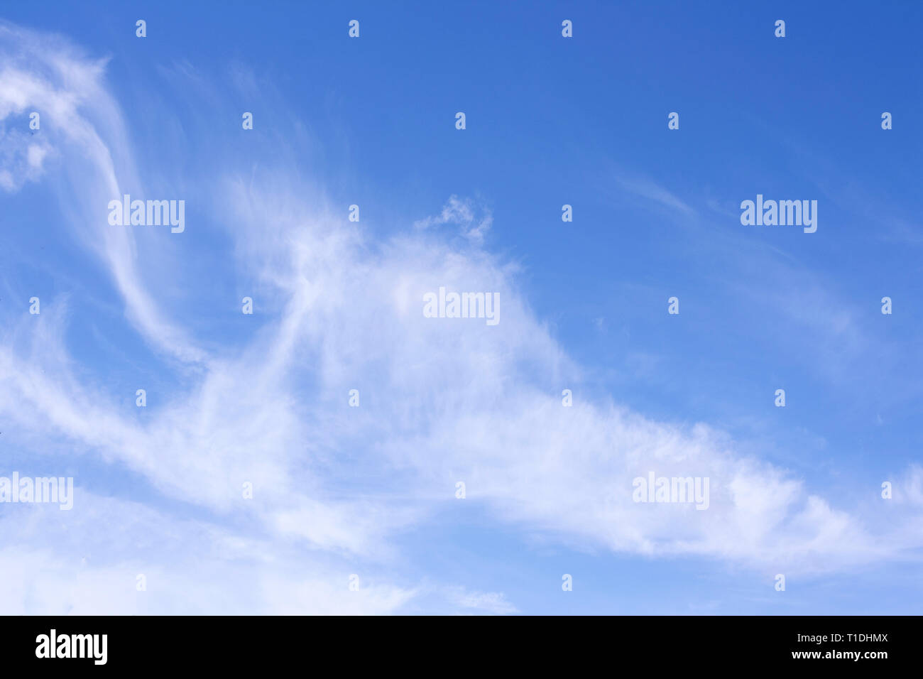 Blue cloudy sky background with beautiful curved clouds Stock Photo - Alamy