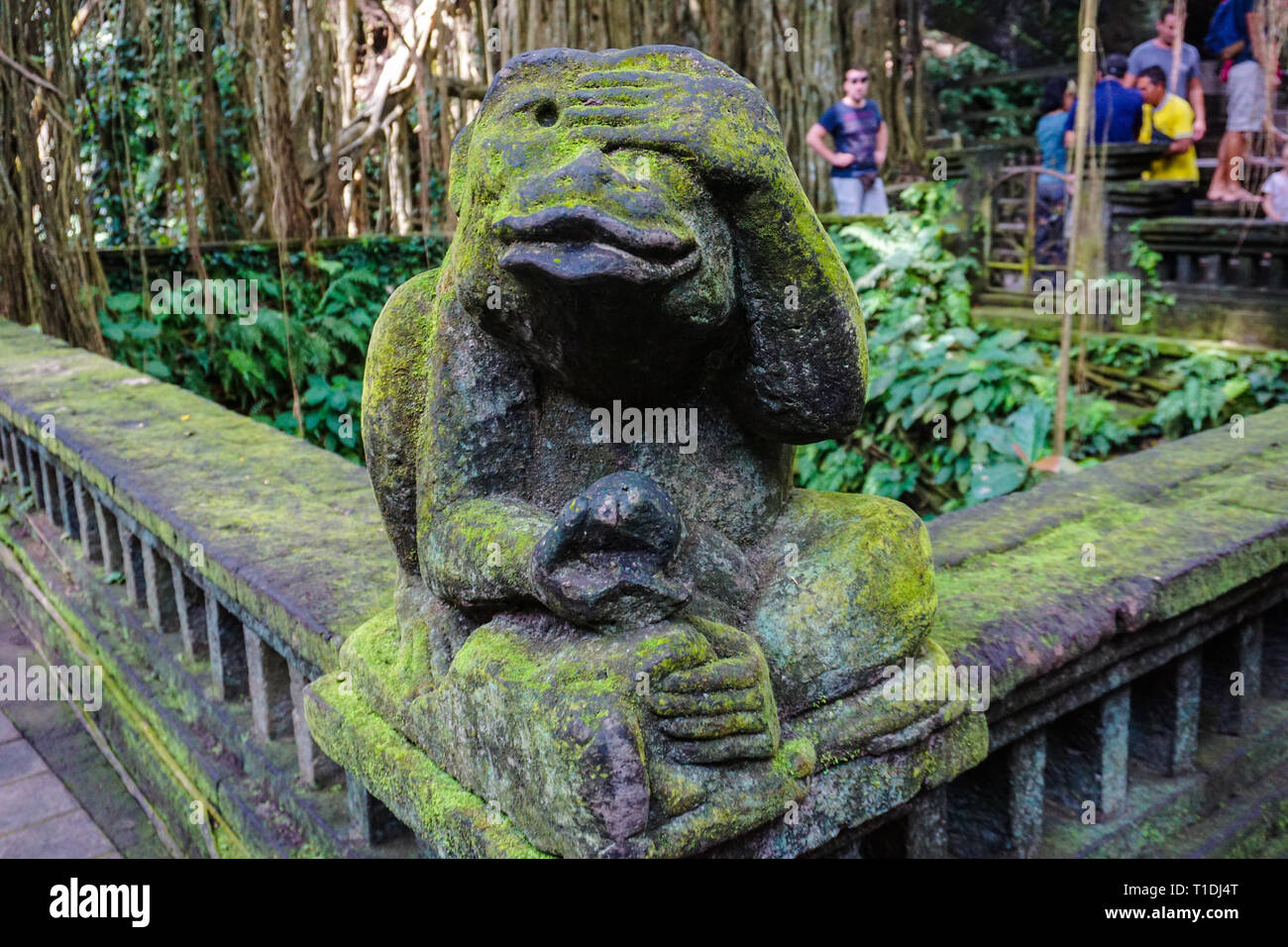 Monkey statue in covered with moss, Indonesia Stock Photo - Alamy