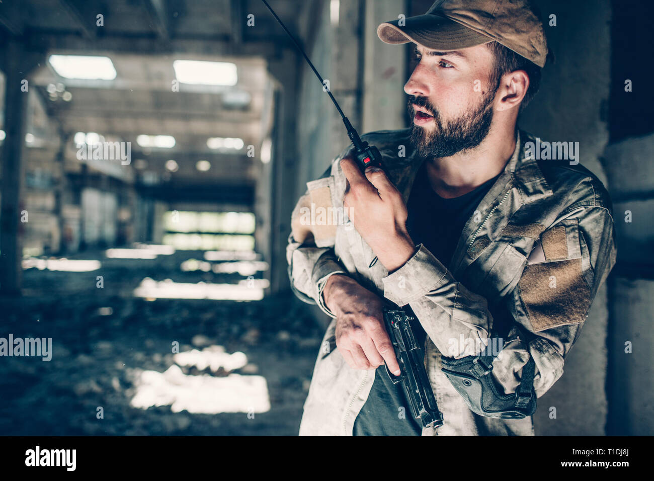 Horizontal picture of soldier talking to portable radio. He is holding ...