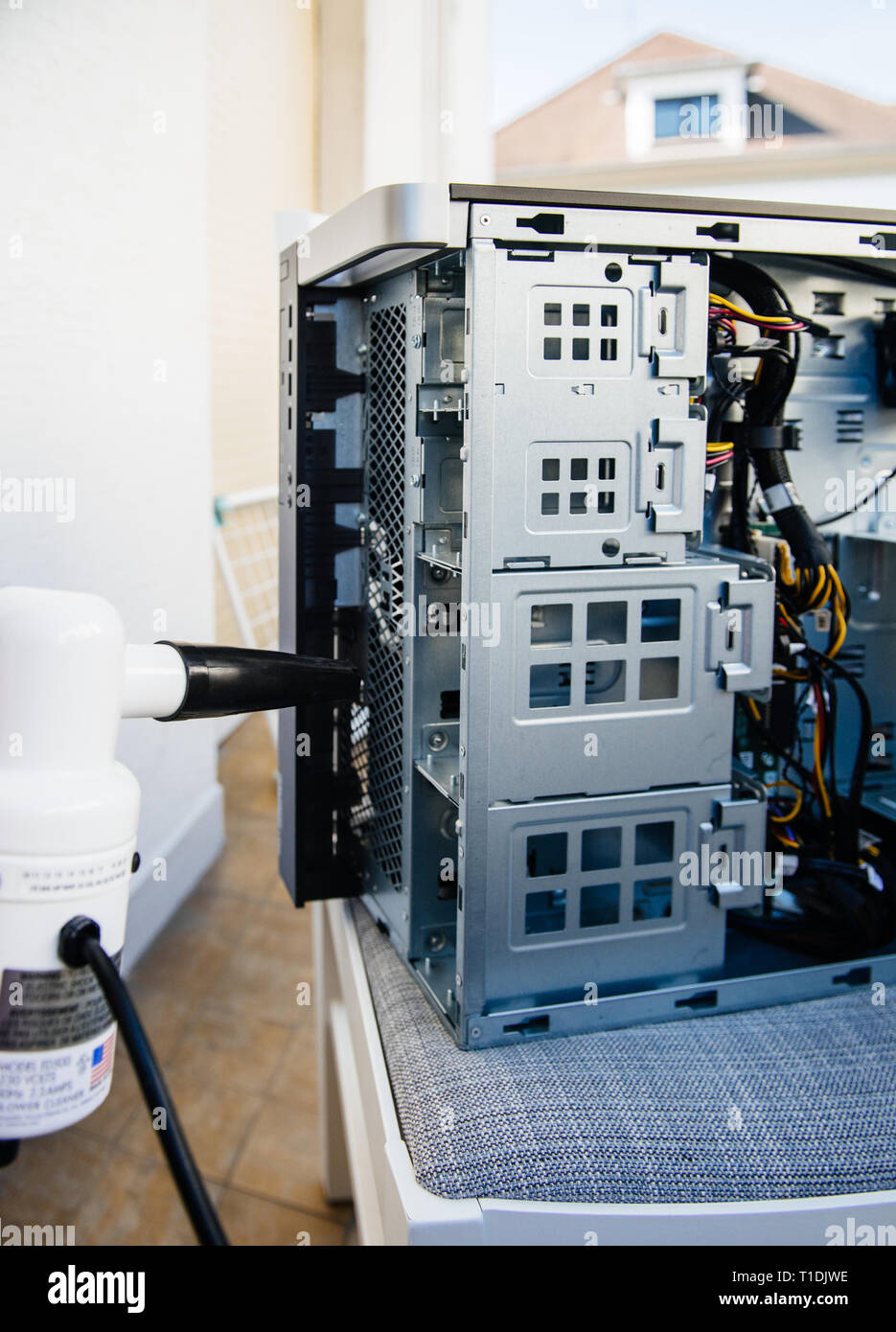 Vertical image of Man hand holding vacuum electric duster pump ...