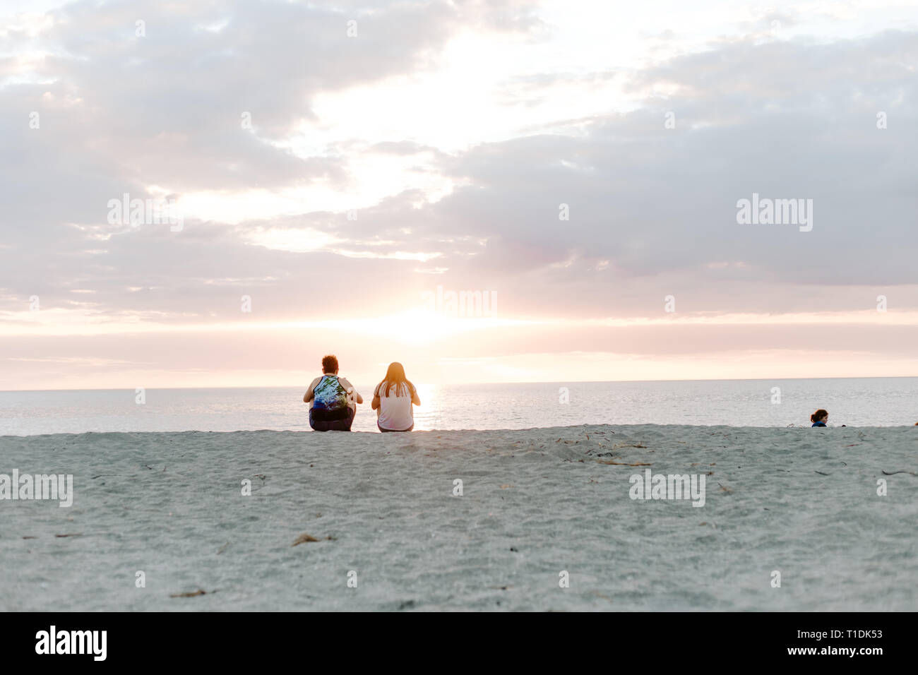 Two People Watching the Beautiful and Serene Sun Set Over the Ocean ...
