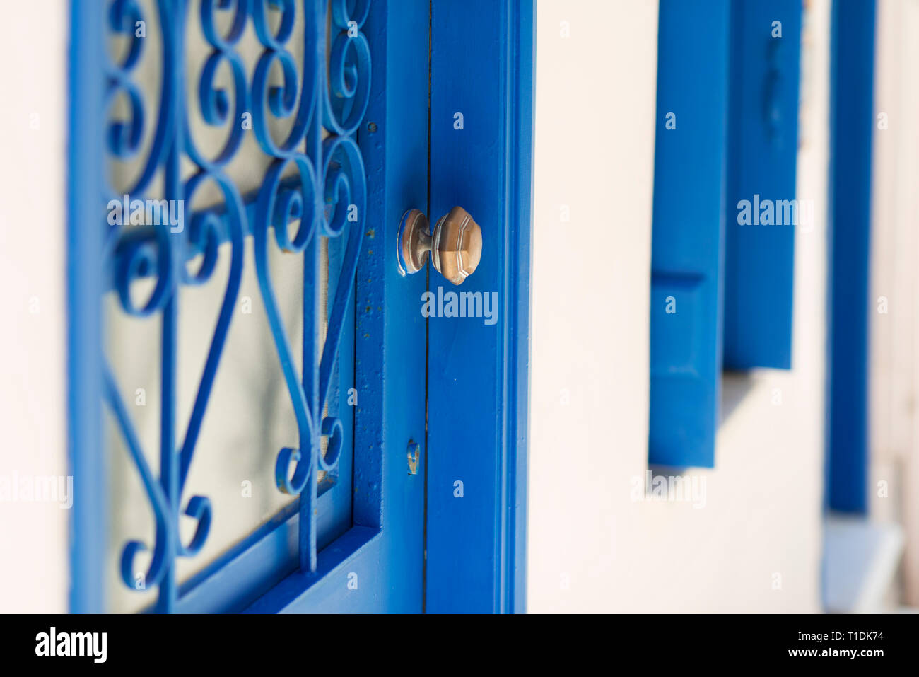 Close up of typical greek architecture home with blue door, blue ...