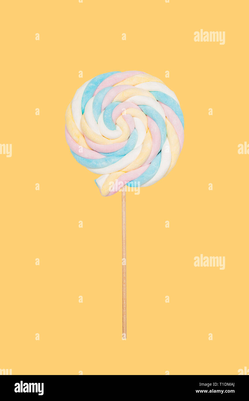 Lollipop on pastel yellow background. Sweet candy concept Stock Photo ...