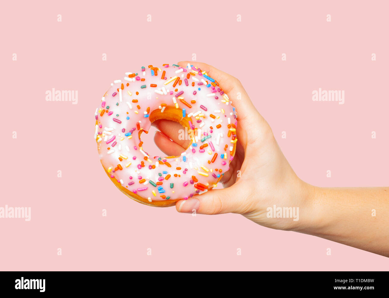 Hand holding donut hi-res stock photography and images - Alamy