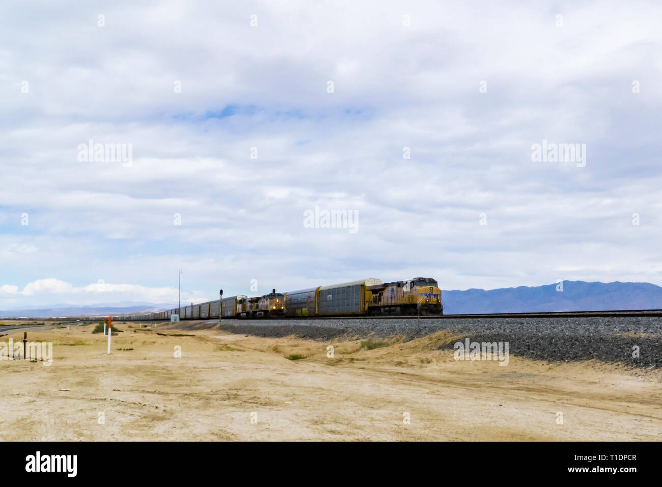 A train with empty auto transporters (on the right) waits on a siding ...