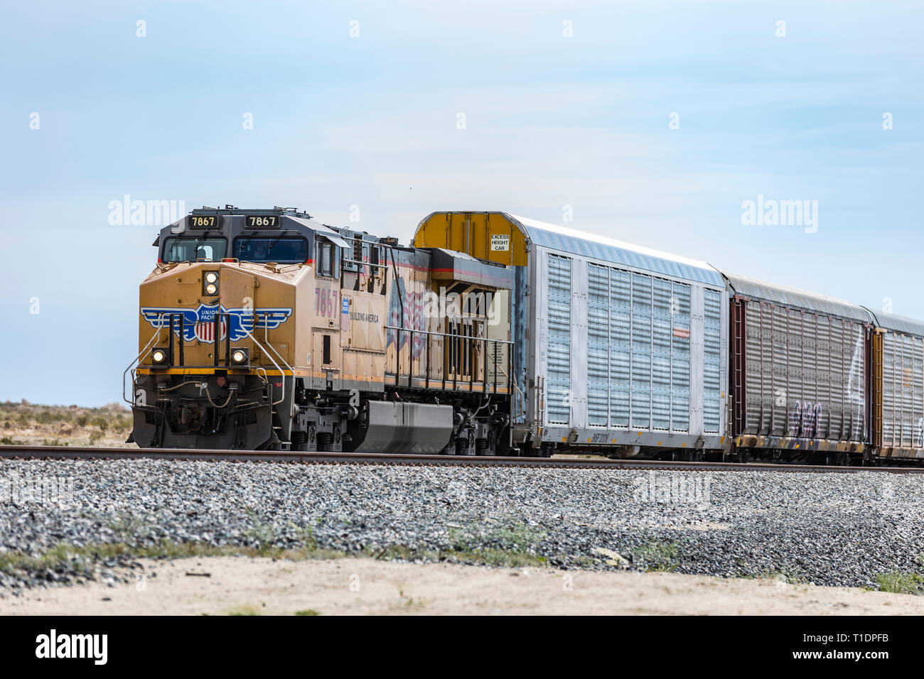 A train with empty auto transporters (on the right) waits on a siding ...