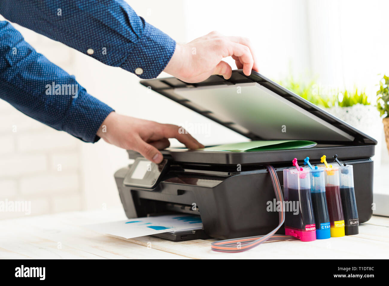 Man's hand making copies. Working with printer Stock Photo - Alamy