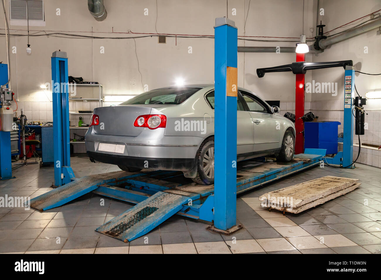 Silver used car stands on the stand wheel alignment convergence of the ...