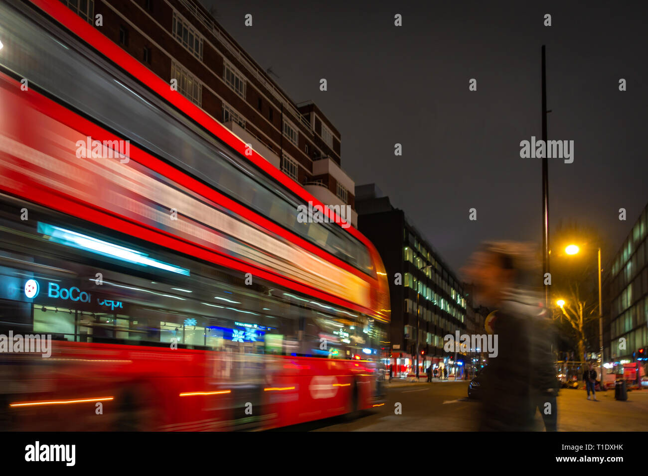 Blurred image taken at night of one of the late night last London buses ...