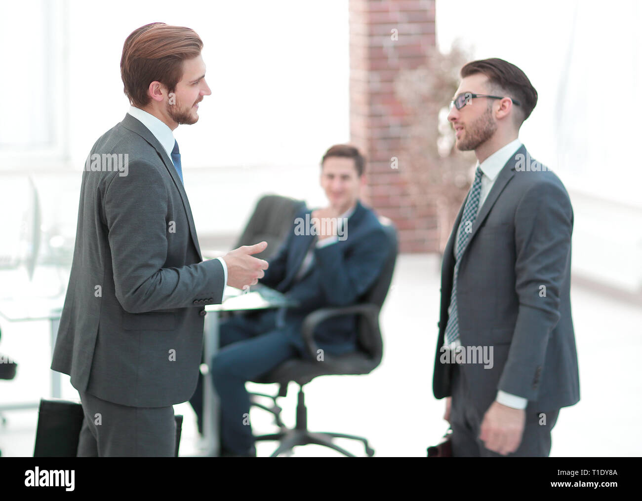 Two employees in business suits work in a conference hall Stock Photo ...