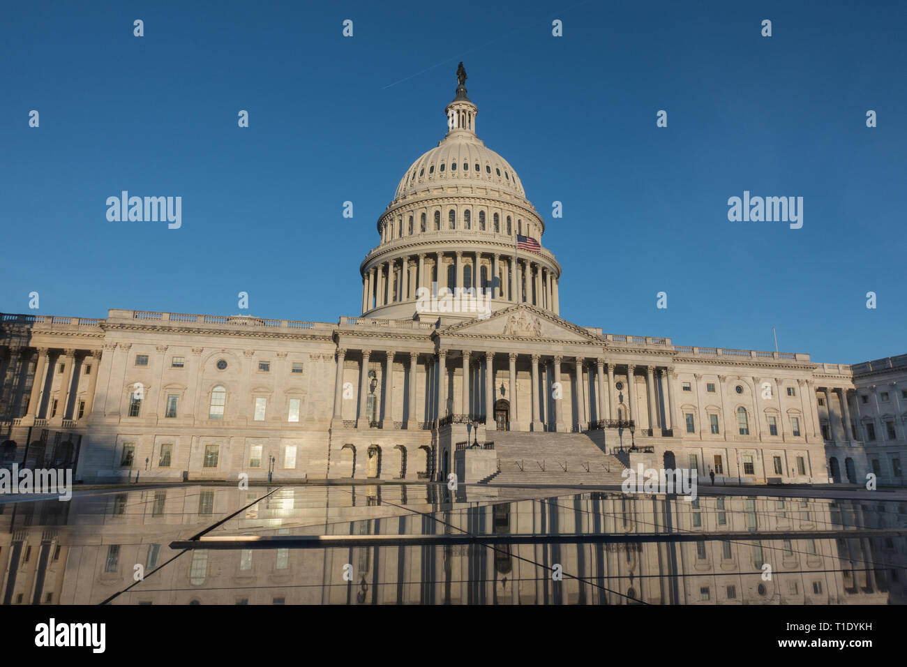 US Capitol; east front reflecting in early morning sun. Reflection on ...