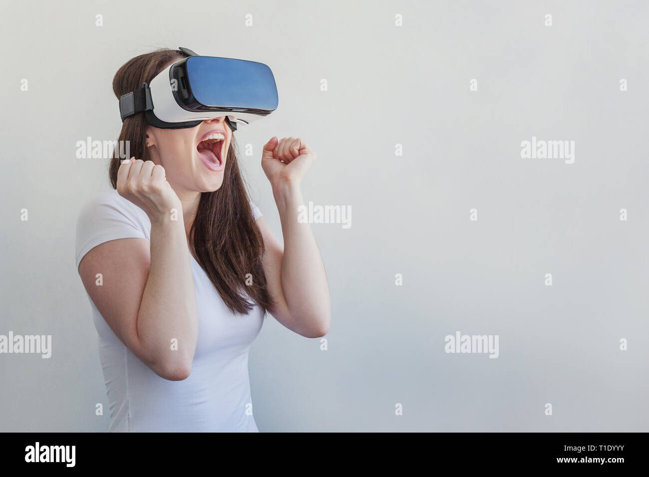 Smile young woman wearing using virtual reality VR glasses helmet ...