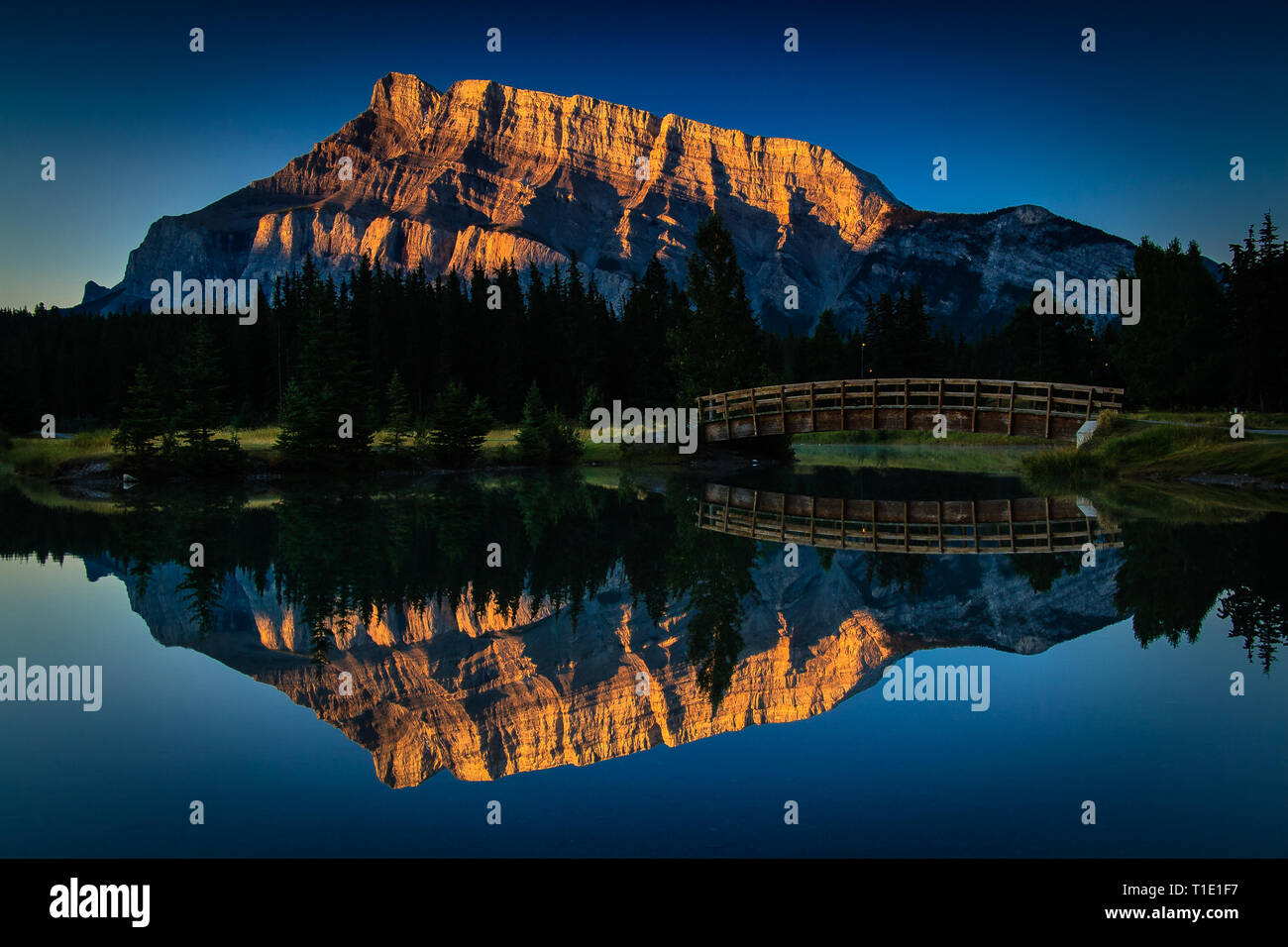 Perfect still reflection of Mount Rundle in Two Jack Lake in Banff ...