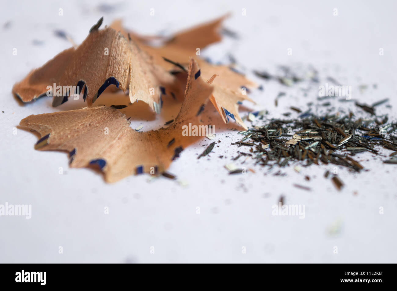Close up pencil peels and black graphite lead waste on a white ...