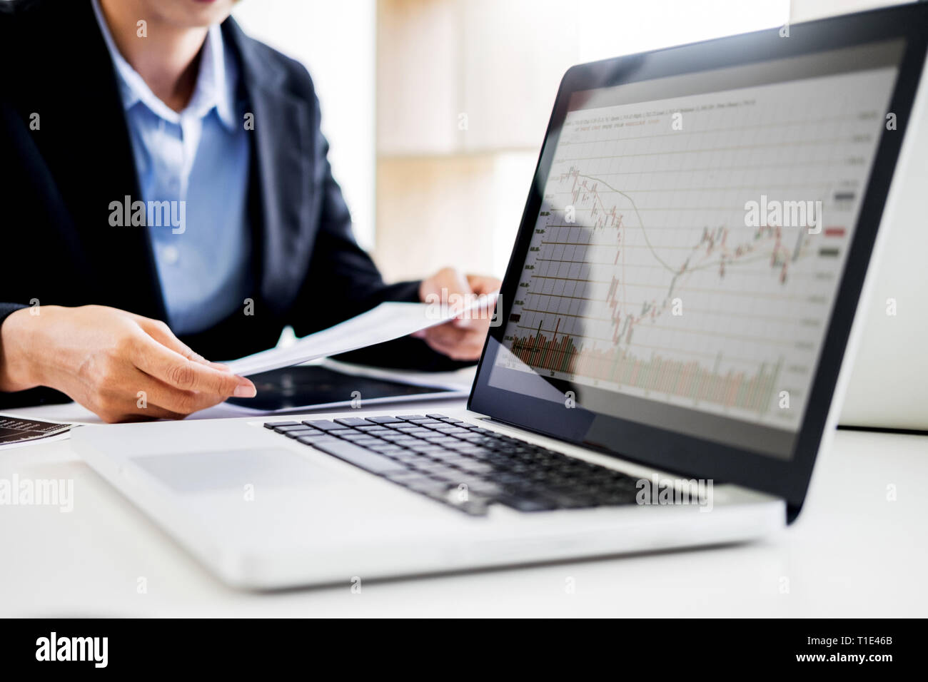Investor analyzing financial reports of stock trading Market Graph ...