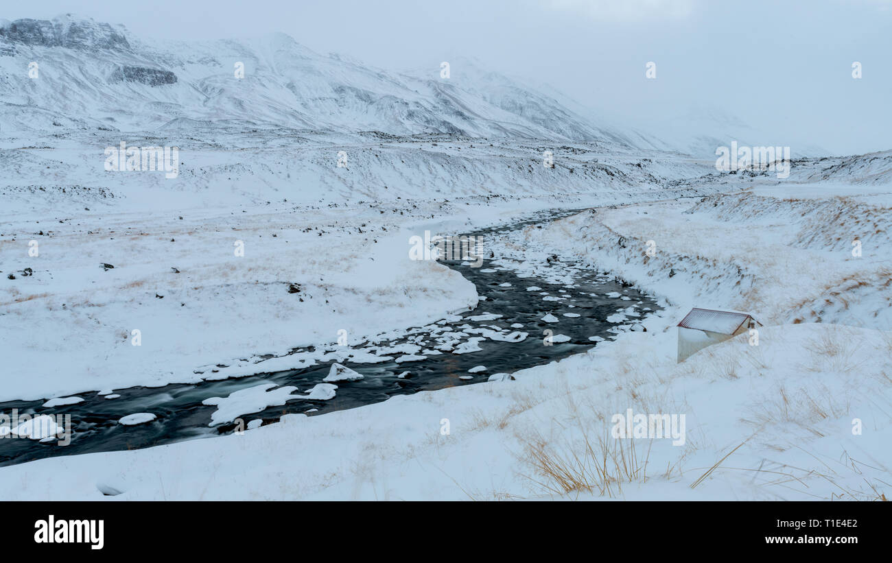 Frozen River Flowing Through Mountains and Snow, Iceland Stock Photo ...