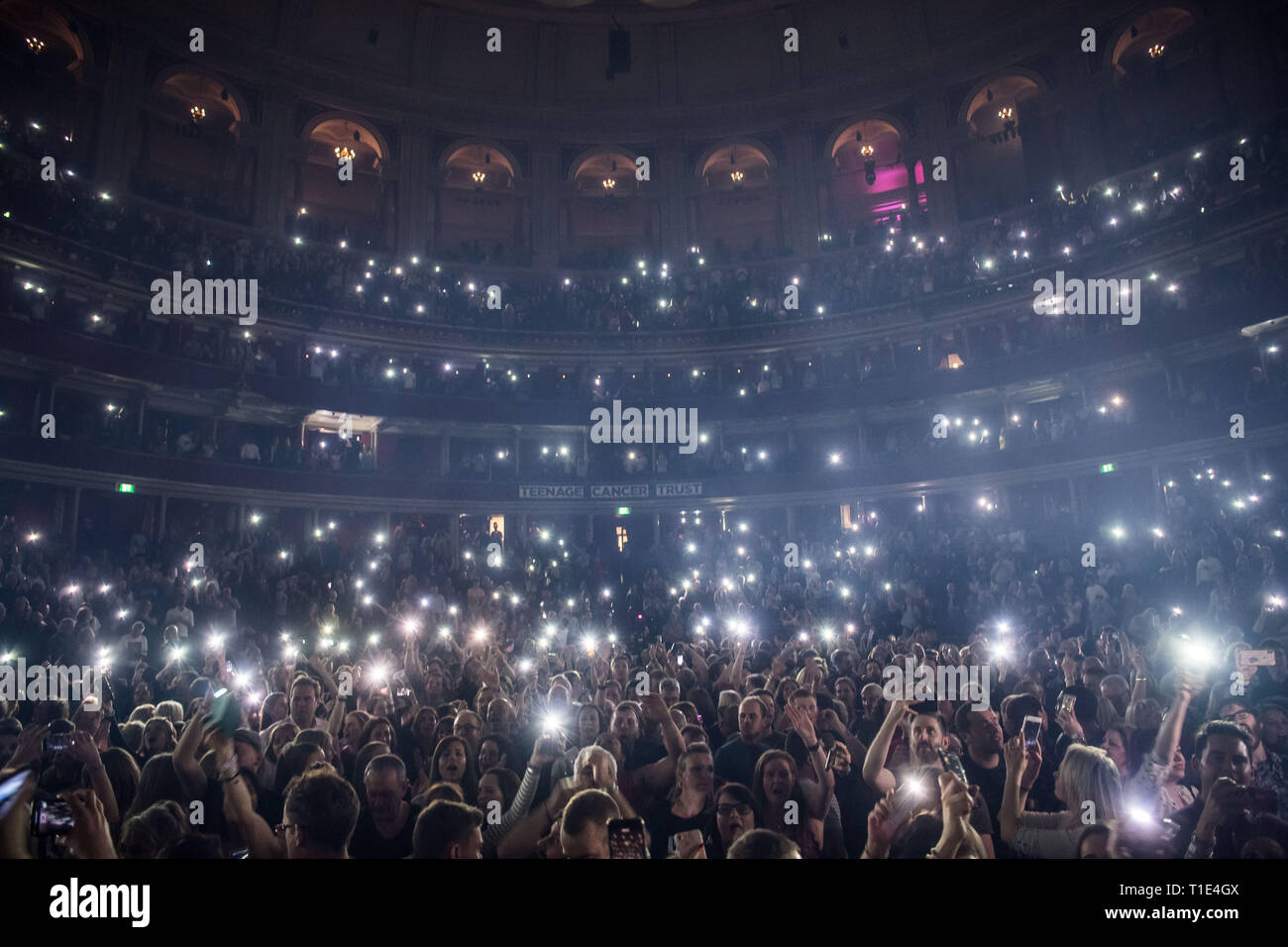 Audience members raise the mobile phone torches at the Rudimental ...