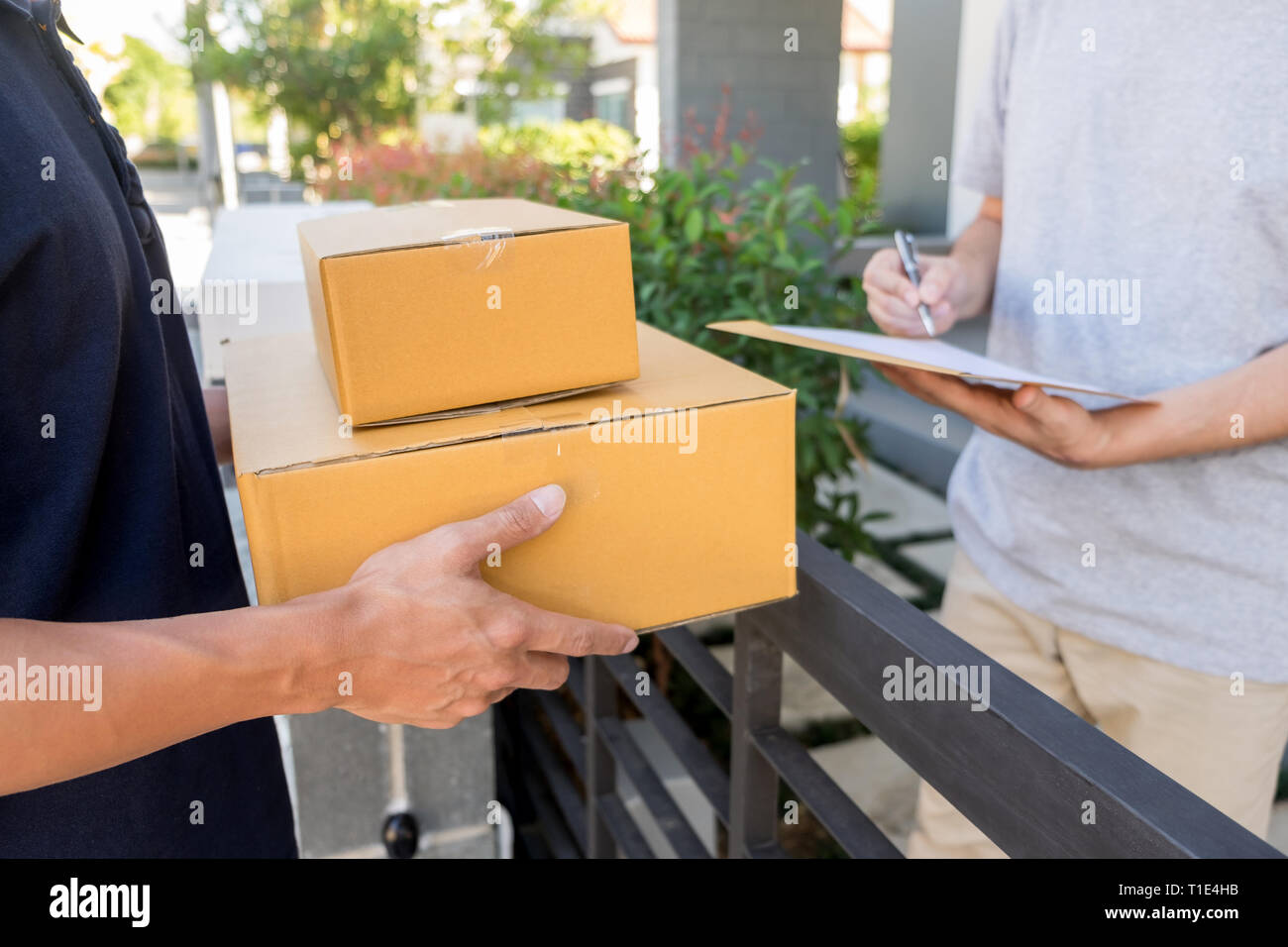 delivery service concept, customer hand receiving a cardboard boxes ...
