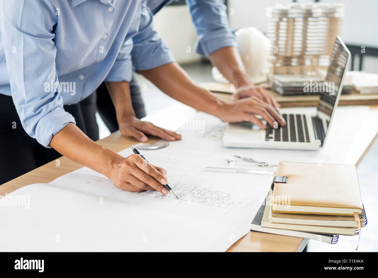 Close-up Of Person's engineer Hand Drawing Plan On Blue Print with ...