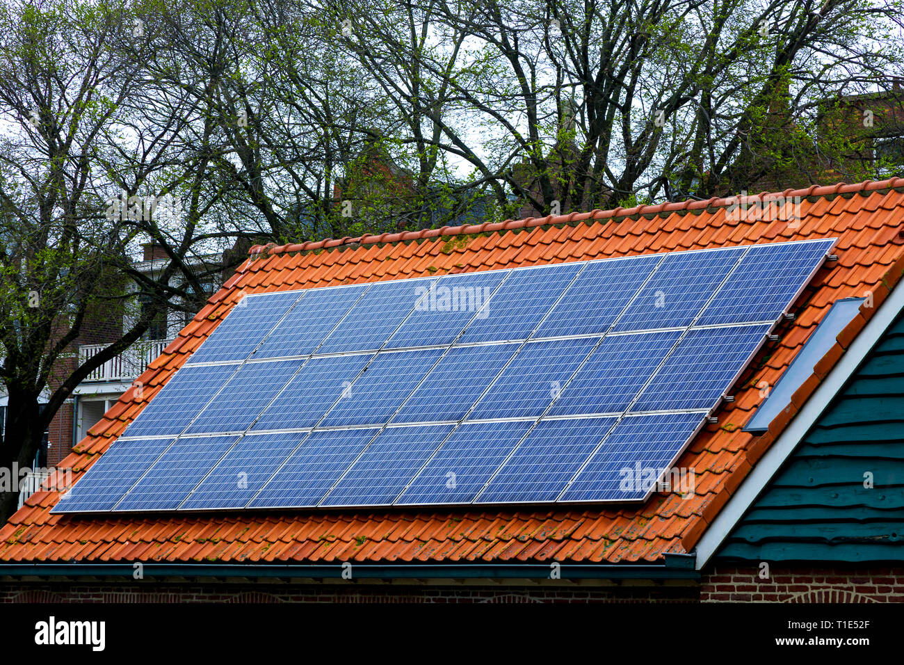 Red tile Roof with solar panels. New solar technologies on the old ...