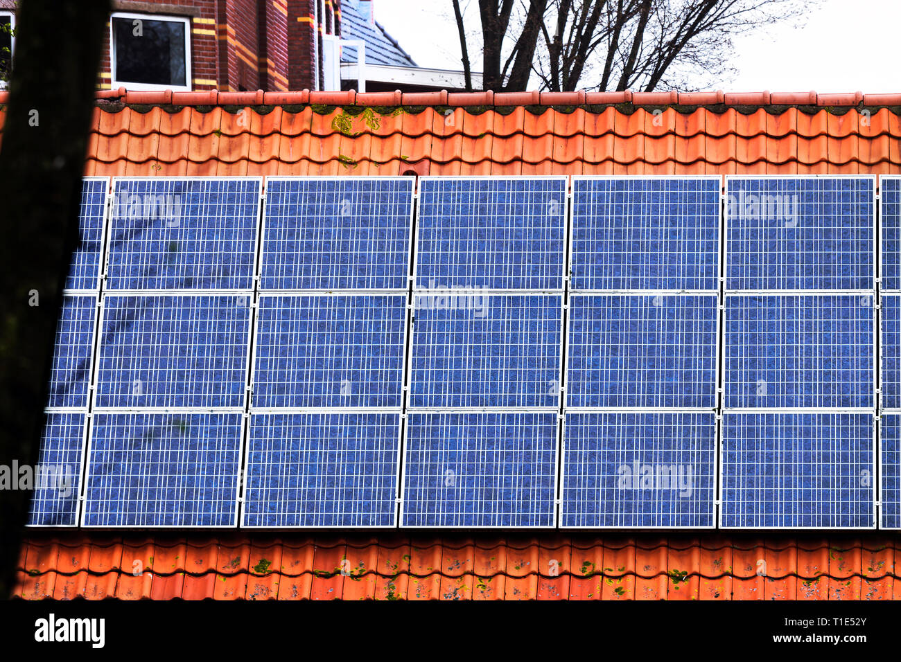 Red tile Roof with solar panels. New solar technologies on the old ...