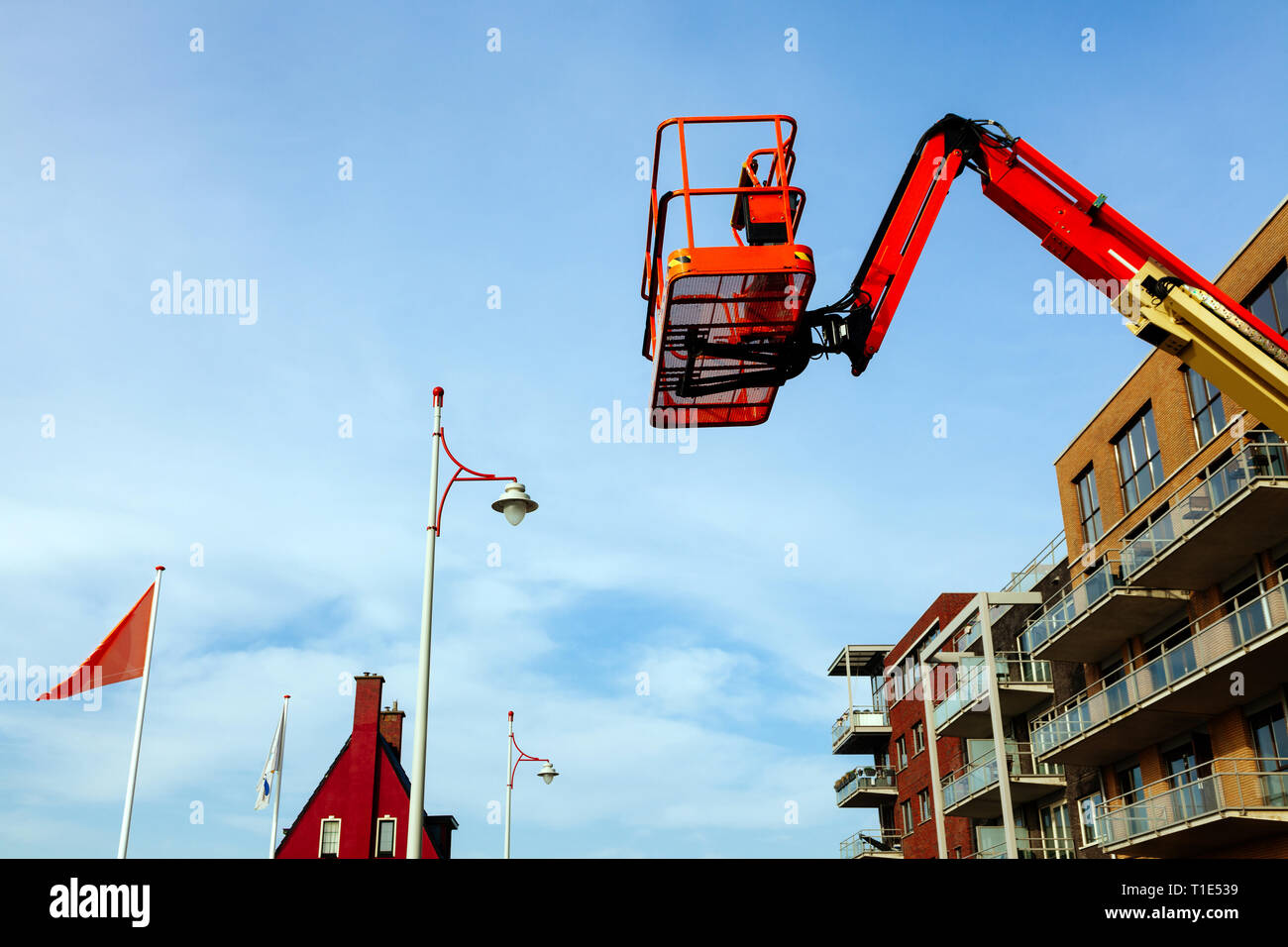 The Used Red Boom Lifts with the blue sky background. Red lift with a ...