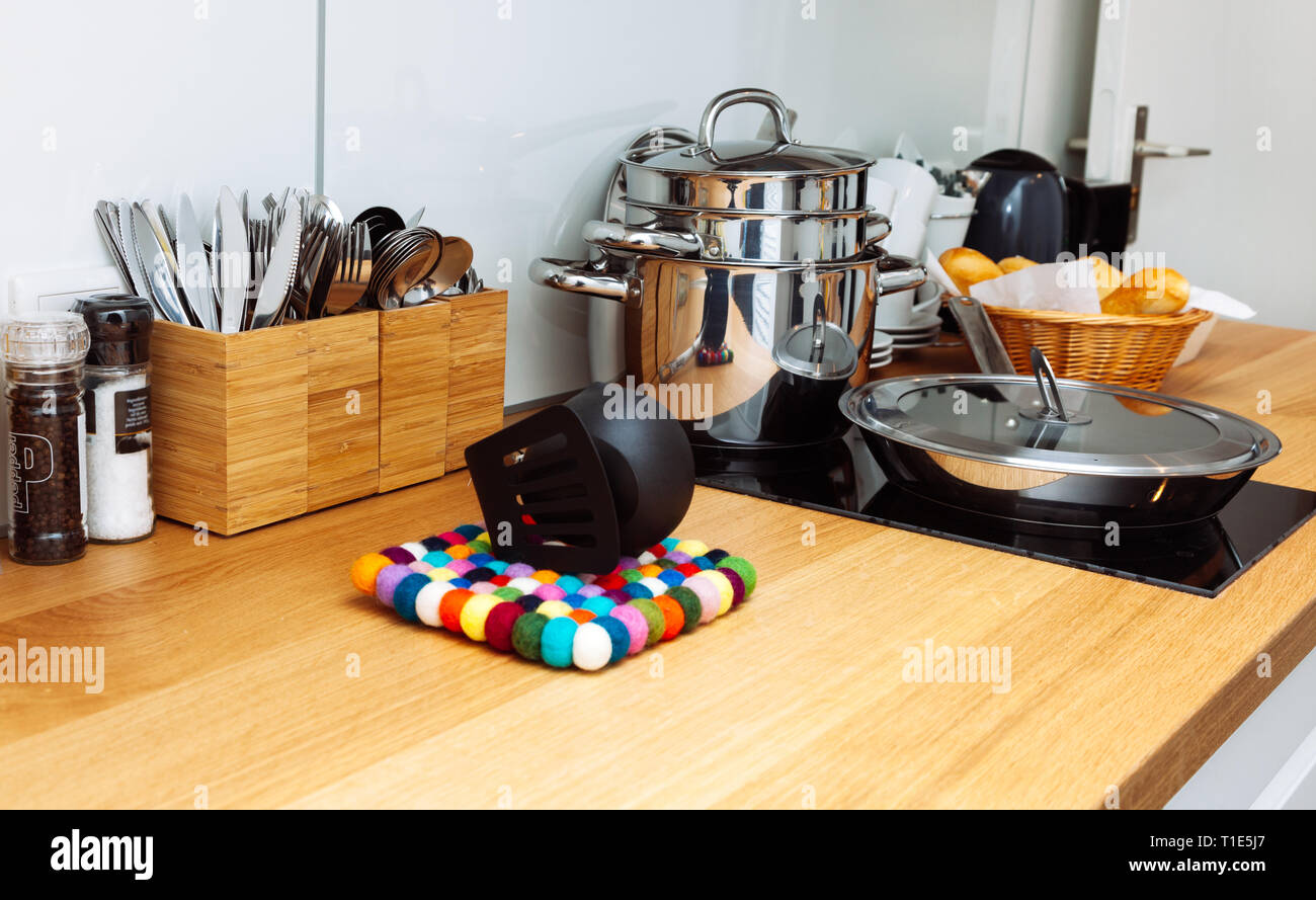 Clean pan and lots of pots on the yellow wooden kitchen table Stock ...