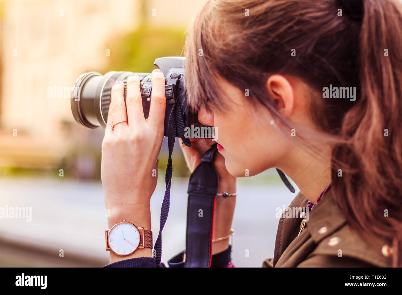 Young beautiful girl is taking a picture with her camera. View from ...