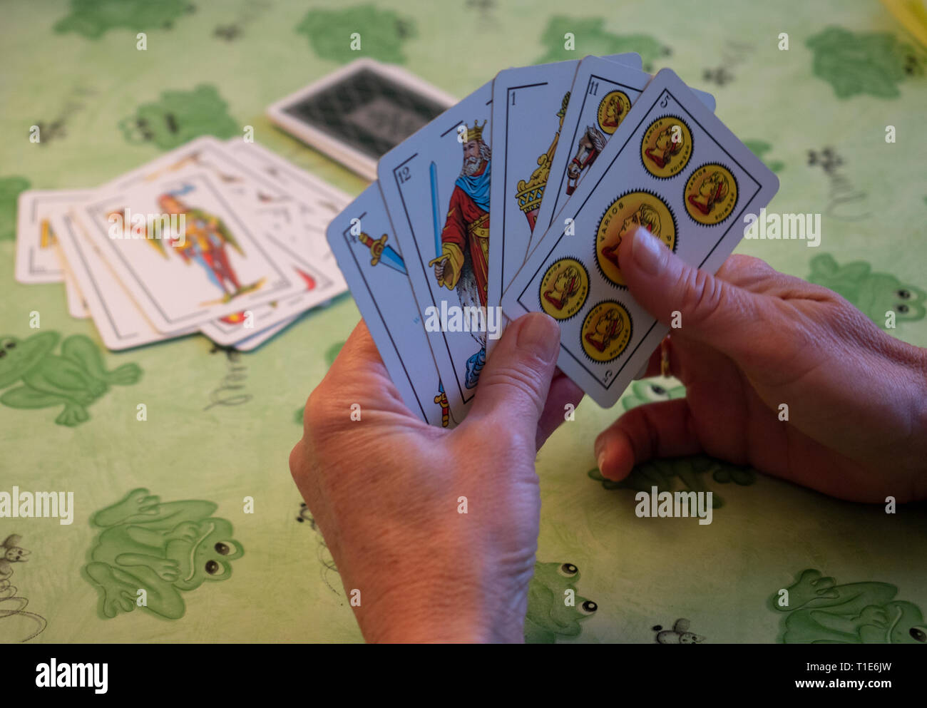 Some friends at home, playing a card game with Spanish cards Stock ...
