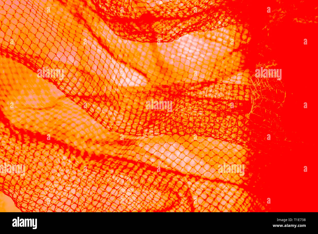 Empty mesh bags of various color at a market place Stock Photo - Alamy