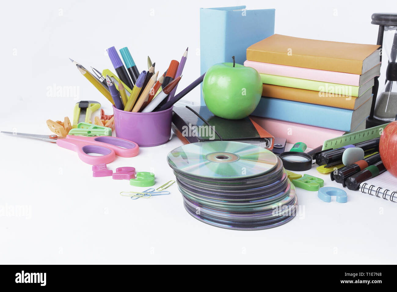 stack of CDs and school supplies isolated on white background.photo ...