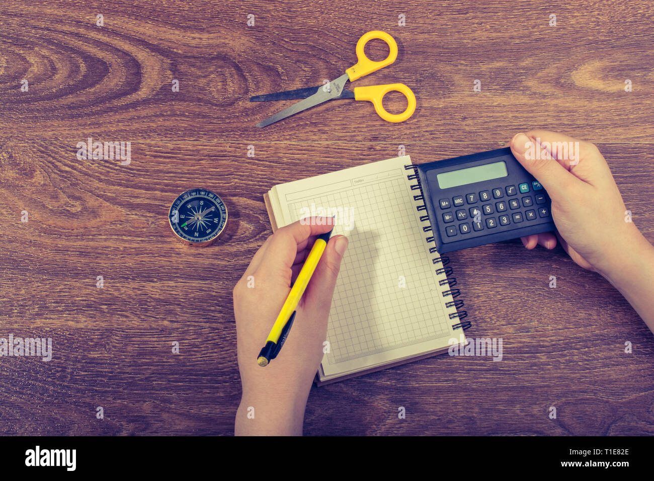 Hand writing in a white notebook on brown background Stock Photo - Alamy