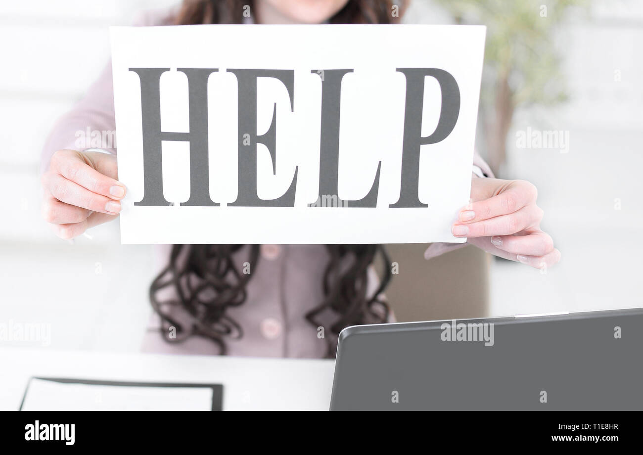 young business woman showing poster that says help Stock Photo - Alamy