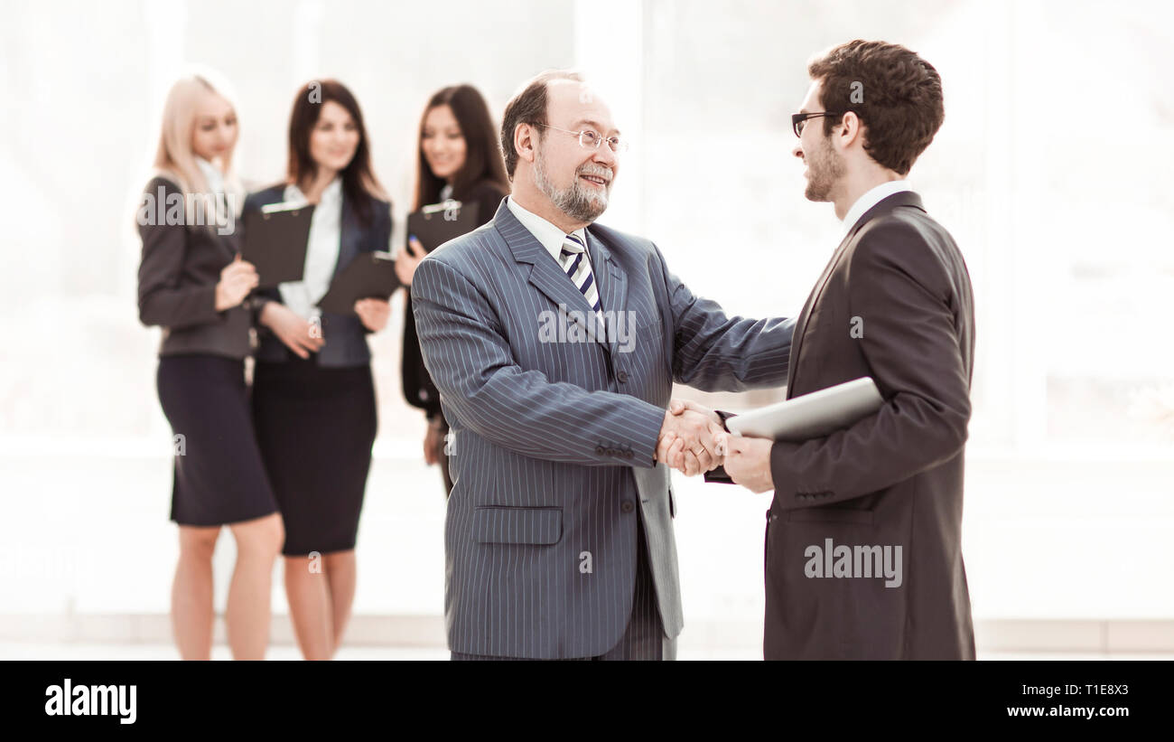 welcome handshake Manager and client on the background of business team ...