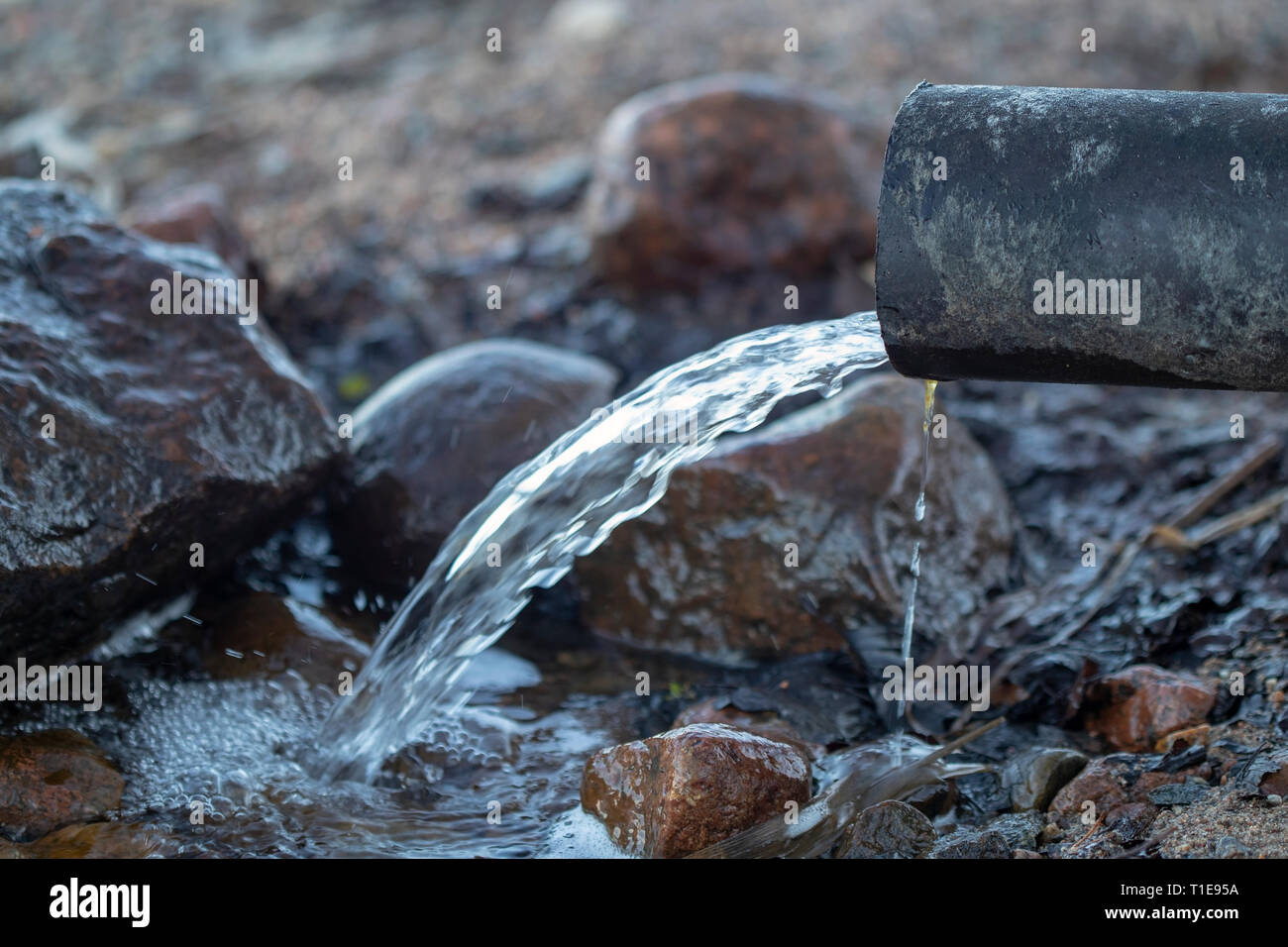water running out of industrial pipe into a lake, Finland Stock Photo ...