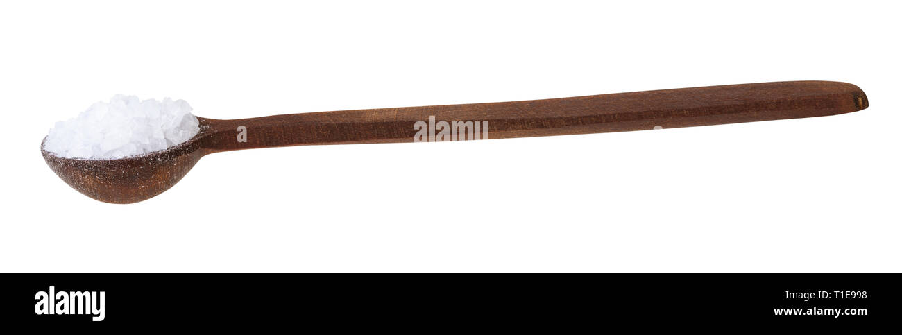 side view of wooden salt spoon with coarse grained Sea Salt isolated on ...