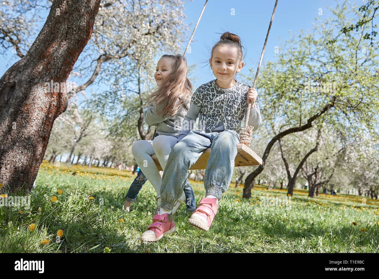 happy family having fun in the spring garden Stock Photo - Alamy