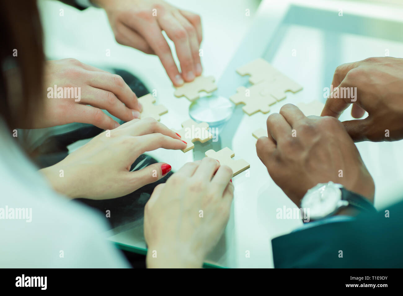 Group people assembling jigsaw hi-res stock photography and images - Alamy