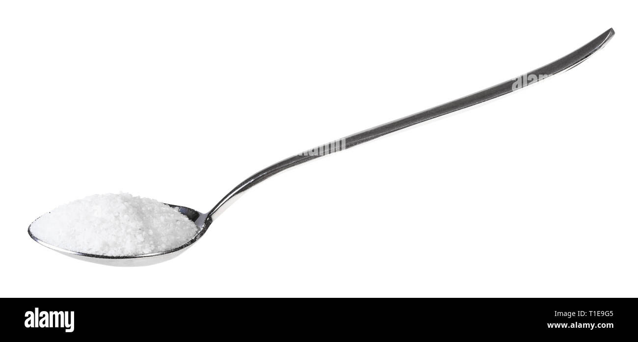 side view of tablespoon with grained Rock Salt isolated on white ...