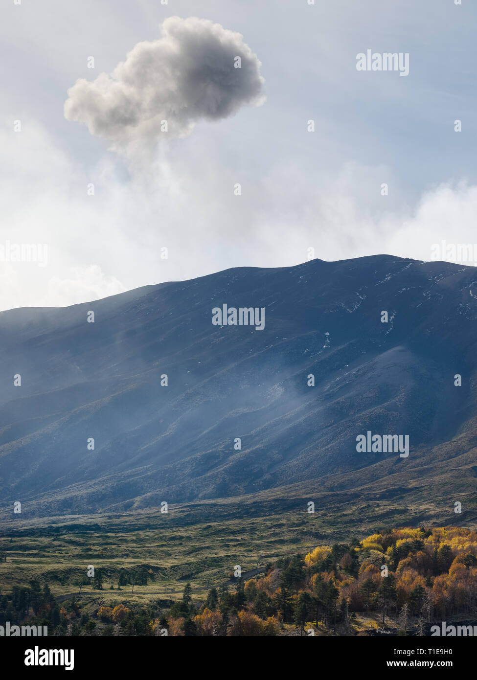 Clouds og volcanic smoke passing over Mount Etna slopes and hills in ...