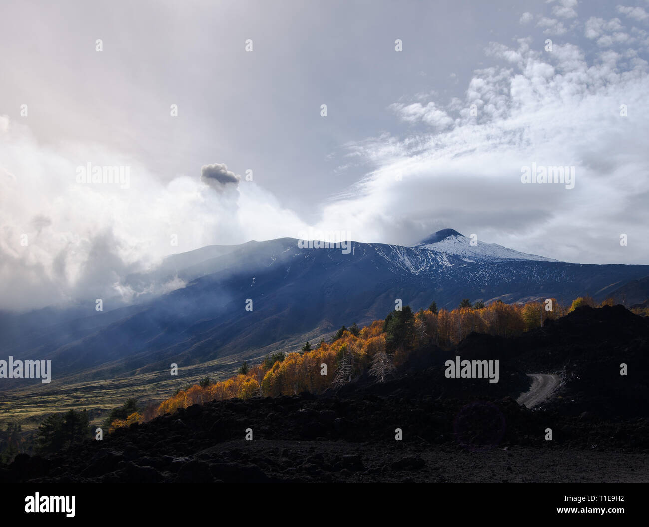 Clouds og volcanic smoke passing over Mount Etna slopes and hills in ...