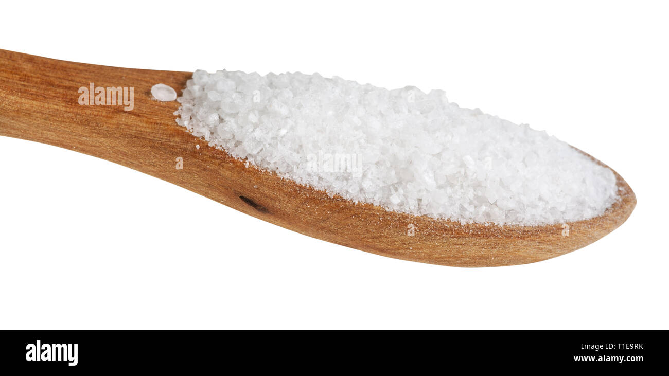 side view of wooden salt spoon with grained Rock Salt close up isolated ...