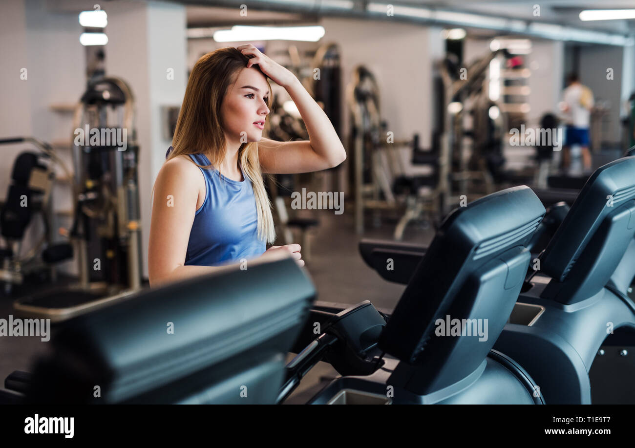 A portrait of young girl or woman doing cardio workout in a gym Stock ...