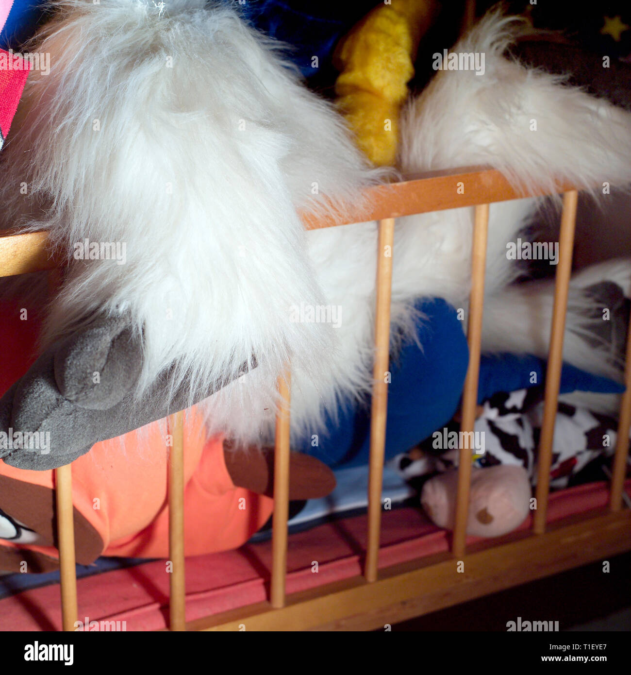 Pile of soft toys in a wooden cot, indoor cropped shot Stock Photo - Alamy