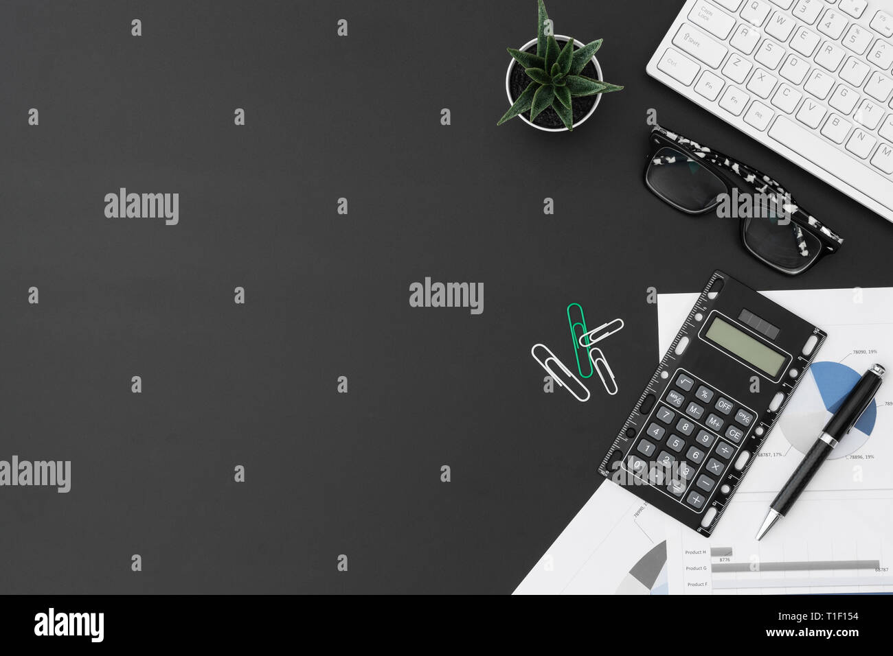 Flat lay office desktop work space of wireless keyboard, report graph ...