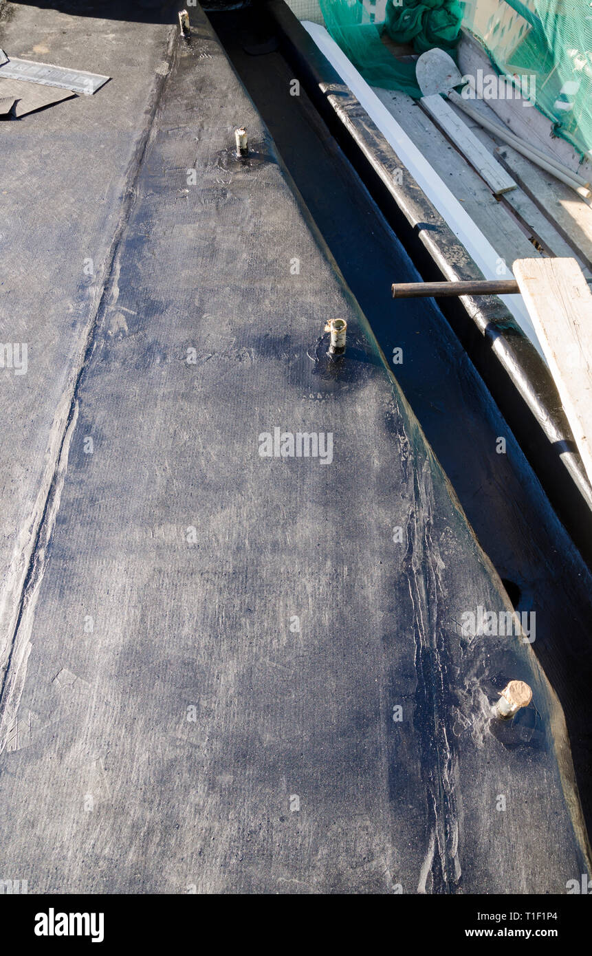 construction work during the renovation of a roof of a building with ...