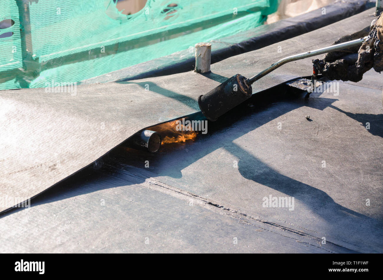 construction work during the renovation of a roof of a building with ...
