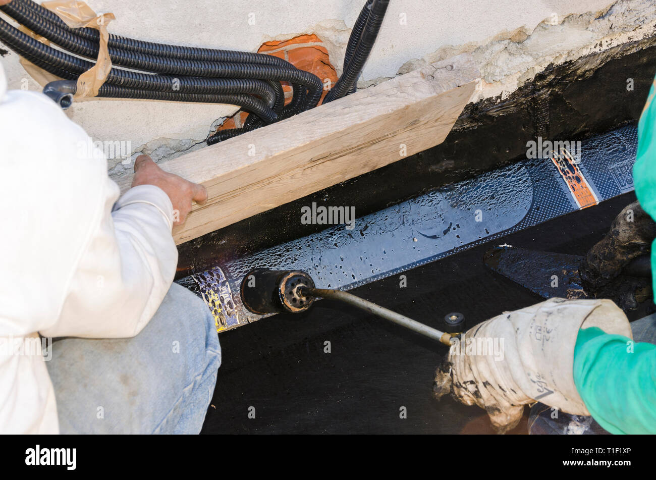 construction work during the renovation of a roof of a building with ...