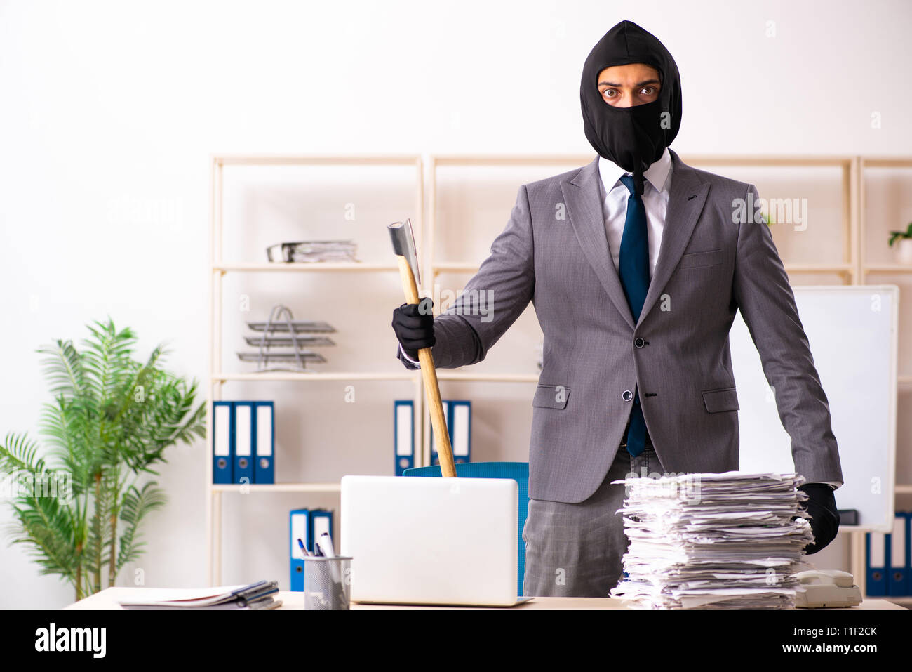 Male gangster stealing information from the office Stock Photo - Alamy